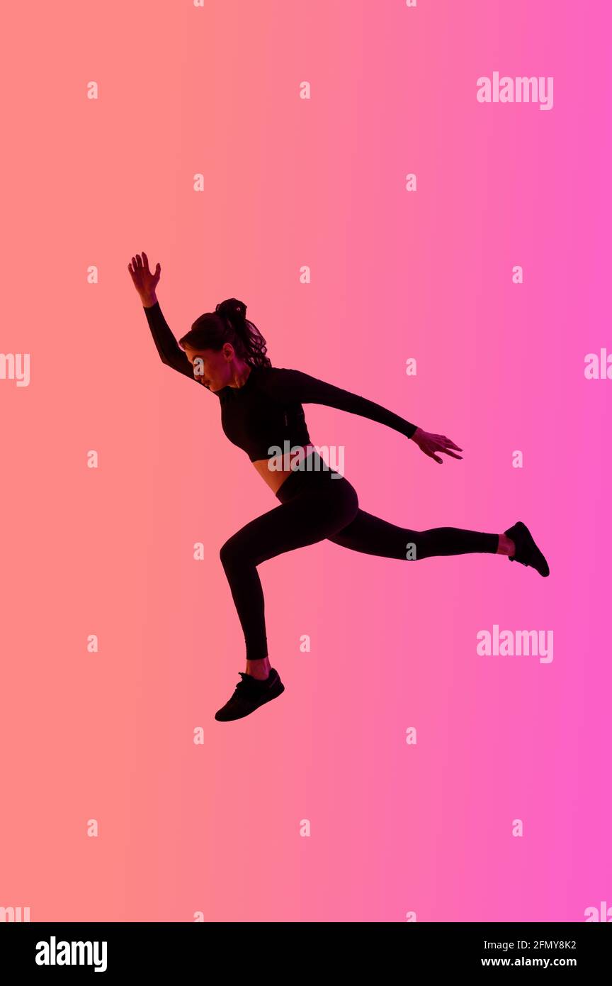 Sports girl on a bright color background does exercises Stock Photo - Alamy