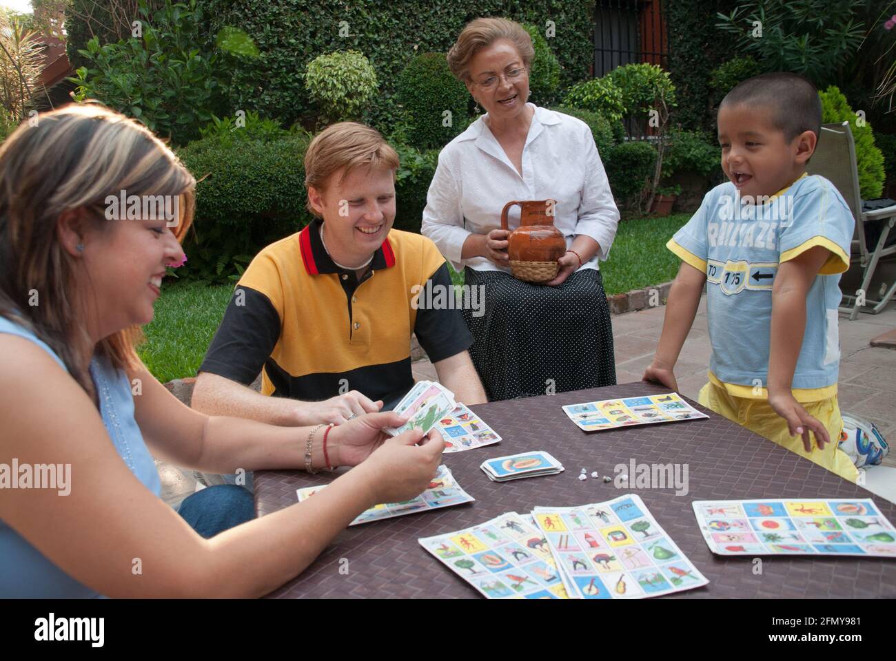 Mexican boy teaching board game to foreigners Stock Photo - Alamy
