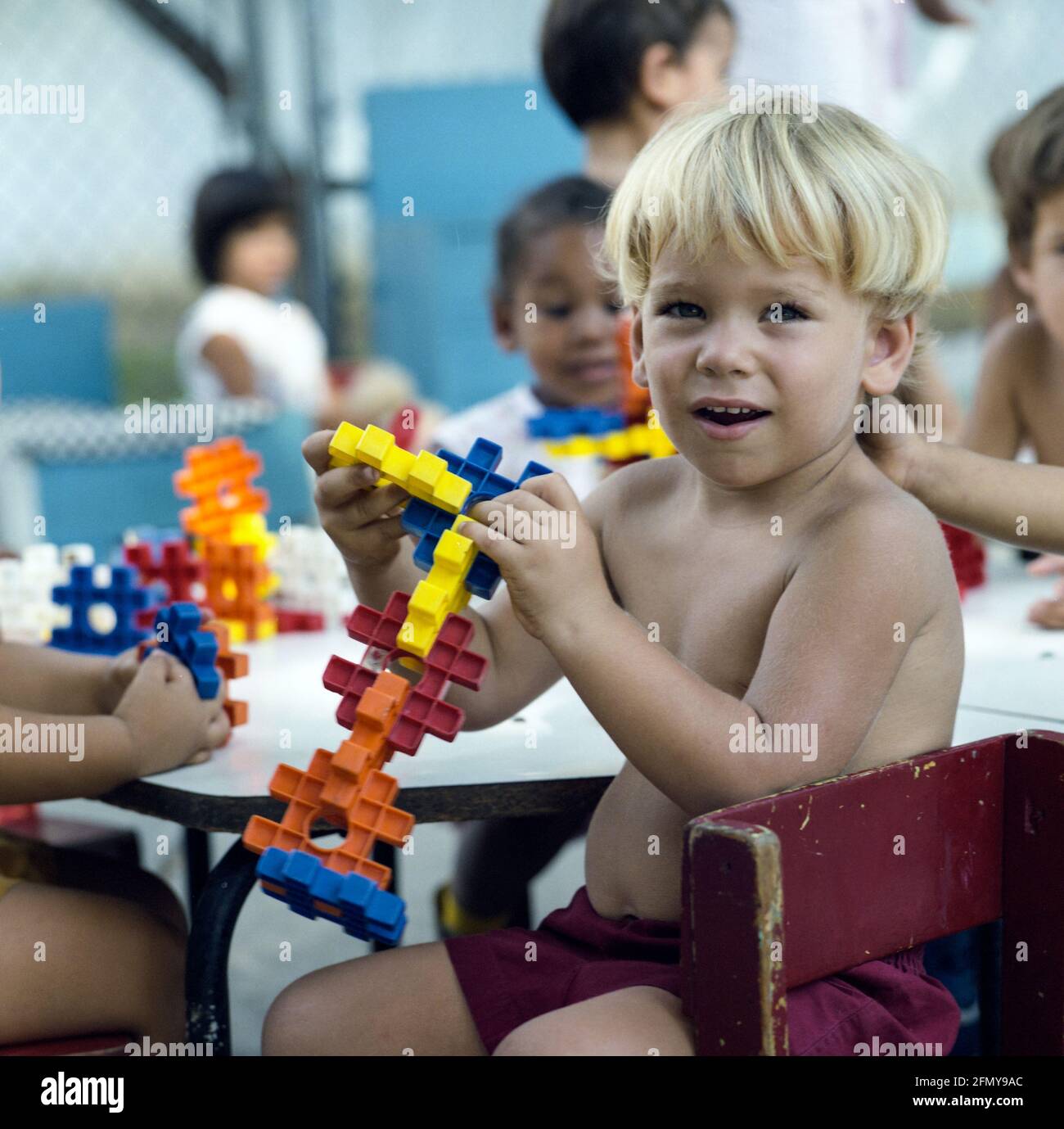 Boy playing with toy pieces Stock Photo - Alamy