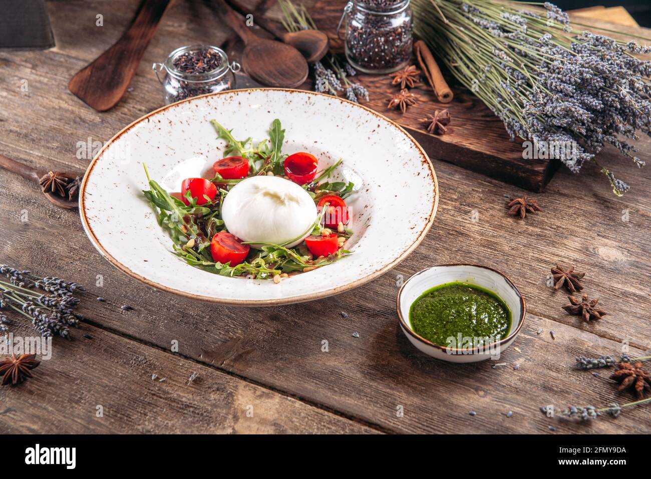 Italian caprese salad with arugula and pesto Stock Photo - Alamy