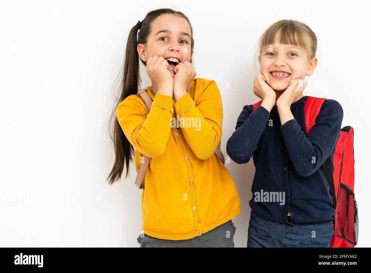 two little girls show emotions. Real emotions. Nice smiling little girl ...
