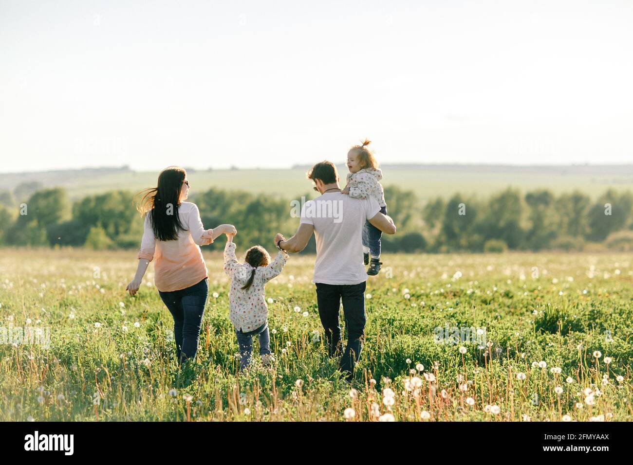 Happy young family spending time together outside in green nature Stock ...