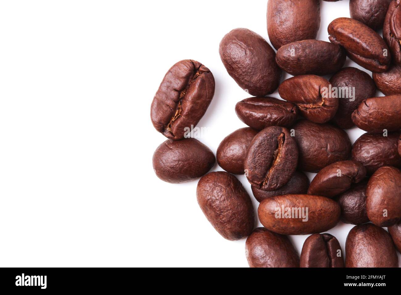 Coffee beans in bulk on a white background Stock Photo - Alamy