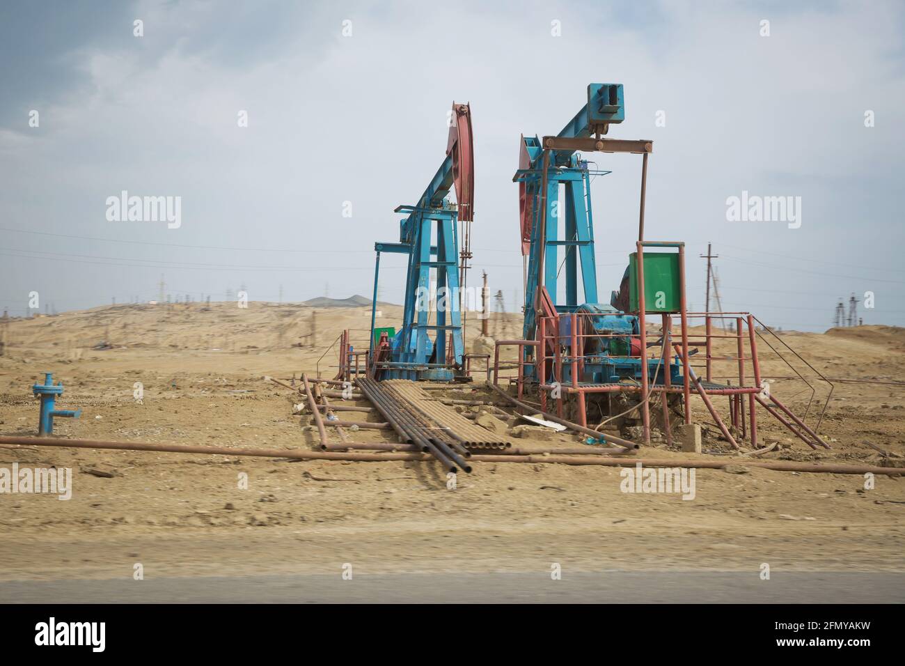Oil and gas drilling rig onshore dessert with dramatic cloudscape ...