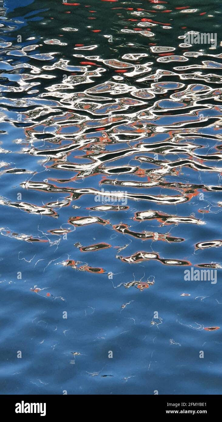 Patterns and reflections in harbour water Stock Photo - Alamy