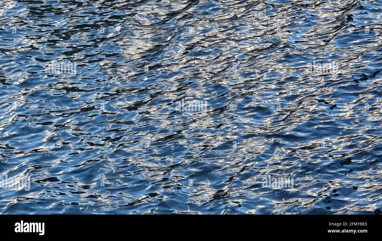Patterns and reflections in harbour water Stock Photo - Alamy