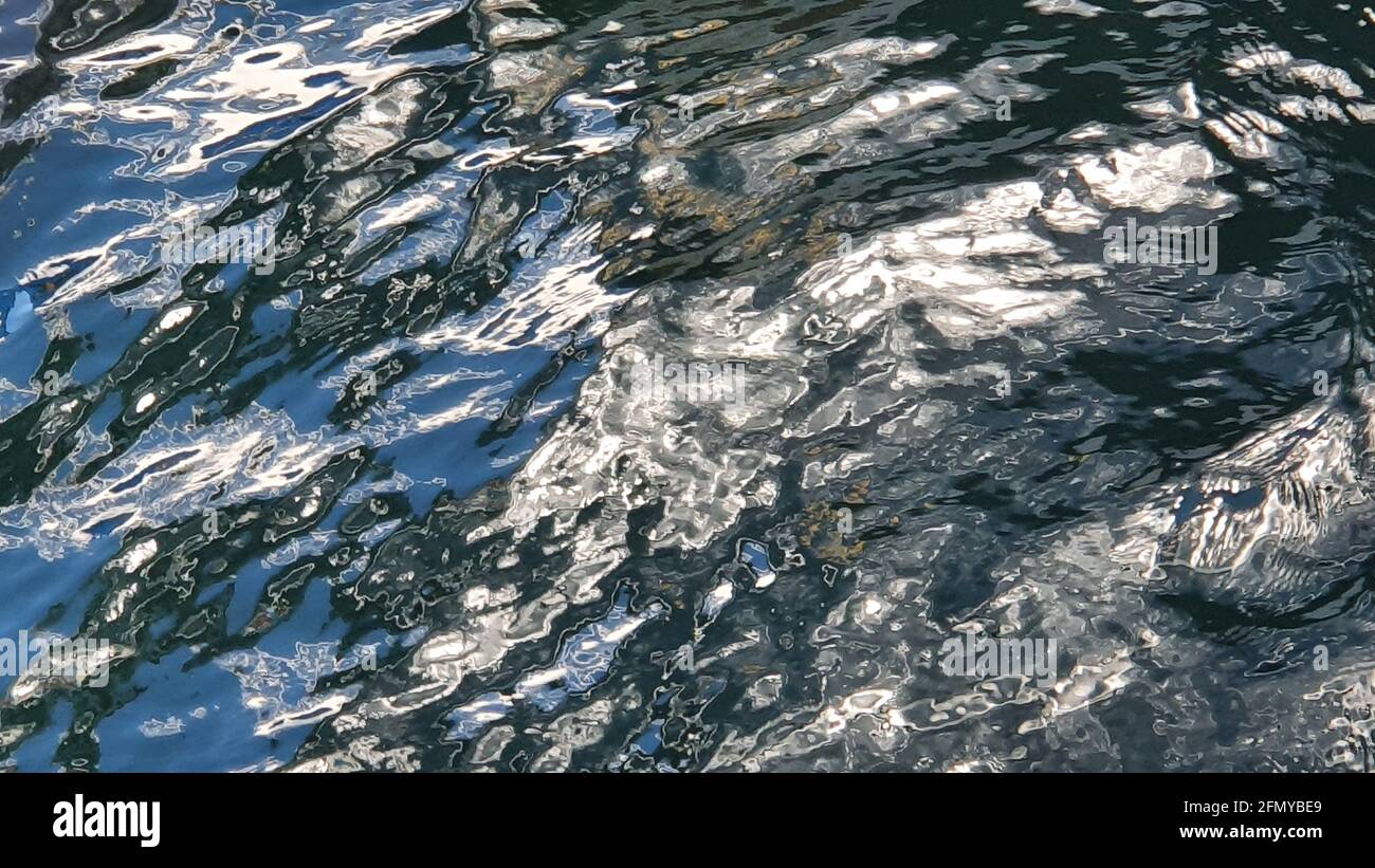 Patterns and reflections in harbour water Stock Photo - Alamy