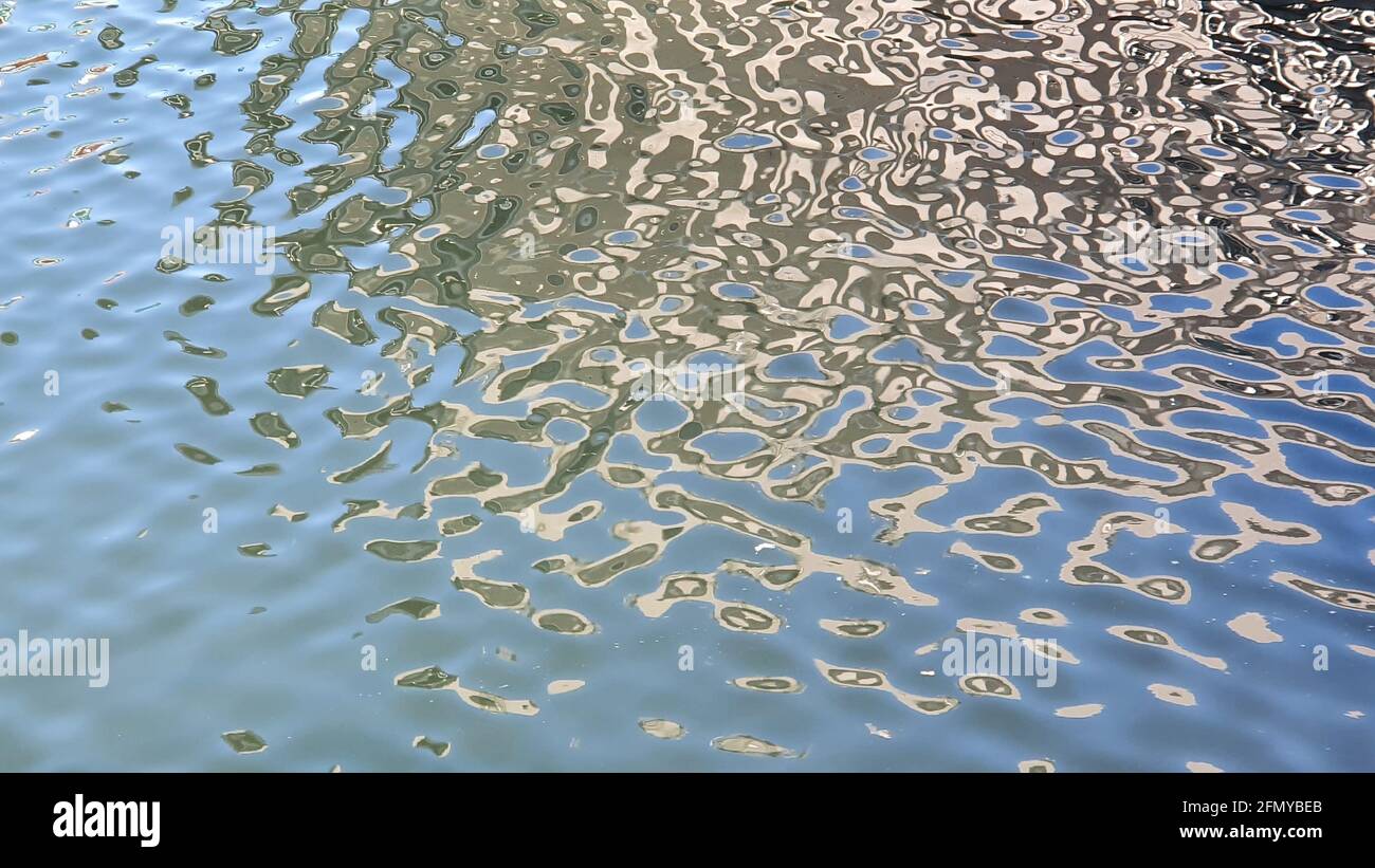 Patterns and reflections in harbour water Stock Photo - Alamy