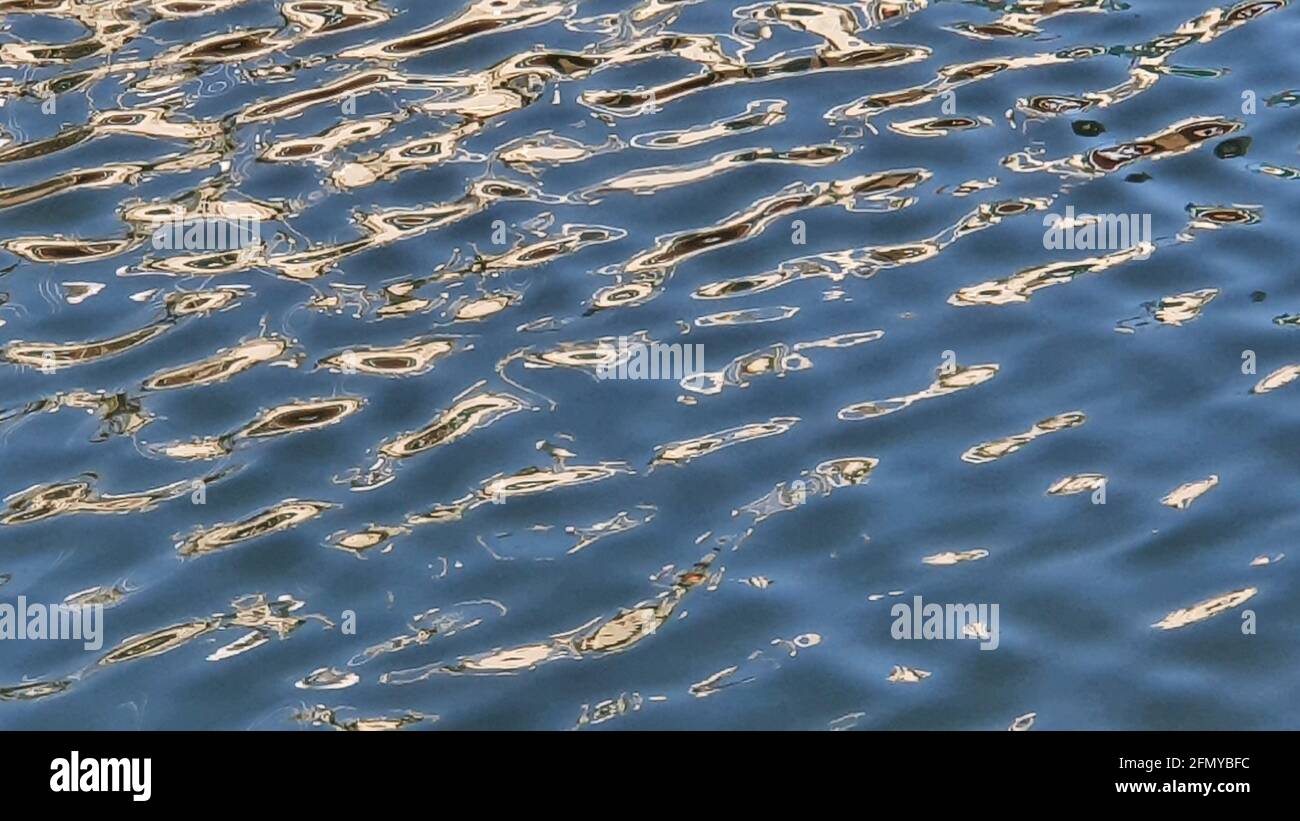 Patterns and reflections in harbour water Stock Photo - Alamy