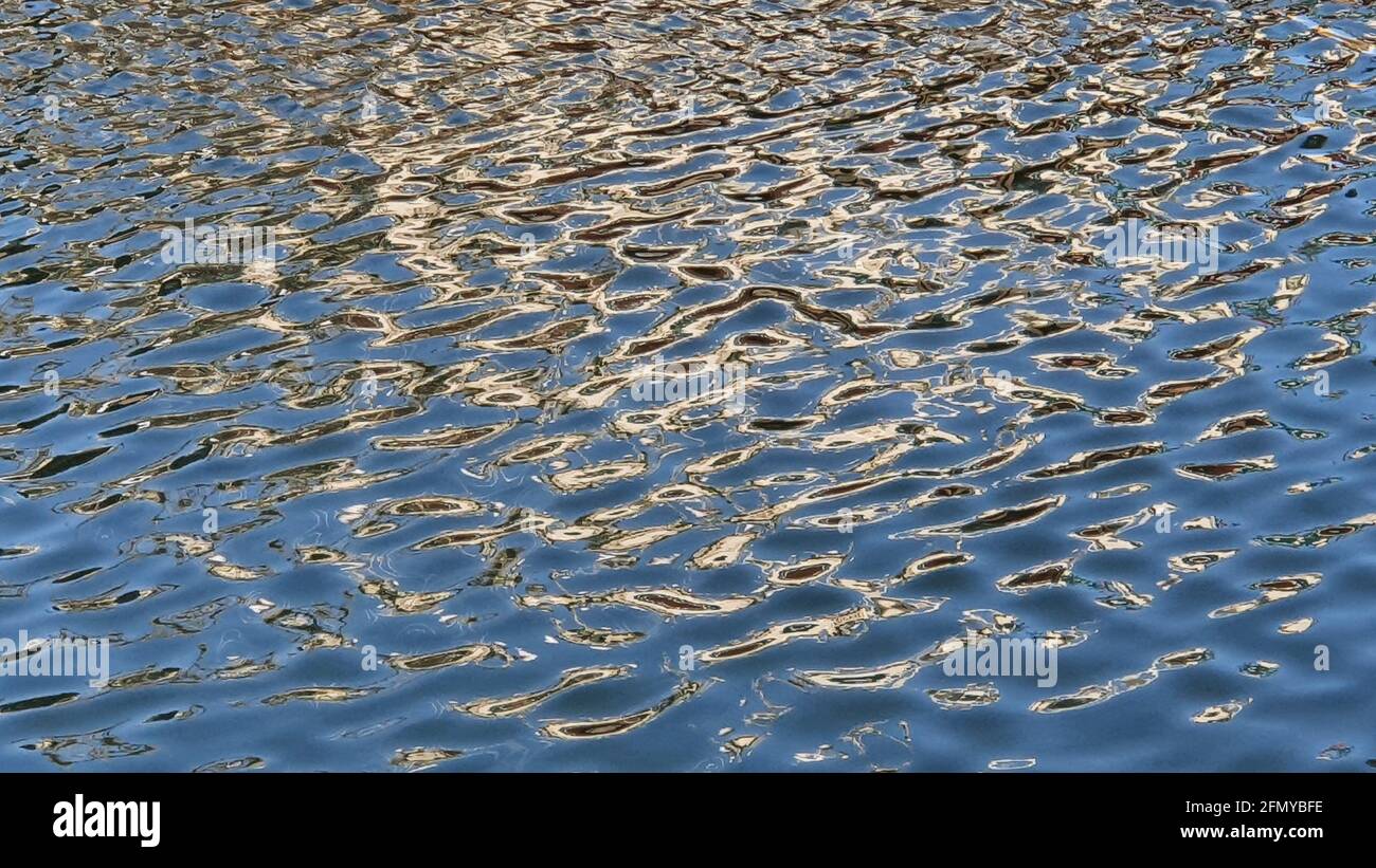 Patterns and reflections in harbour water Stock Photo - Alamy