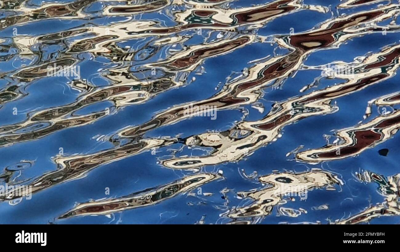 Patterns and reflections in harbour water Stock Photo - Alamy