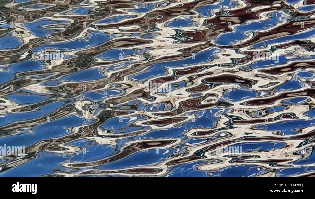Patterns and reflections in harbour water Stock Photo - Alamy