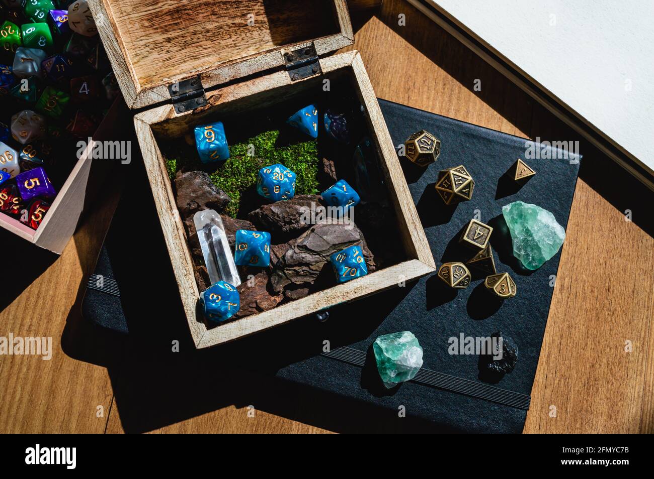 Image of a wooden box with blue role-playing game dice on top of a ...