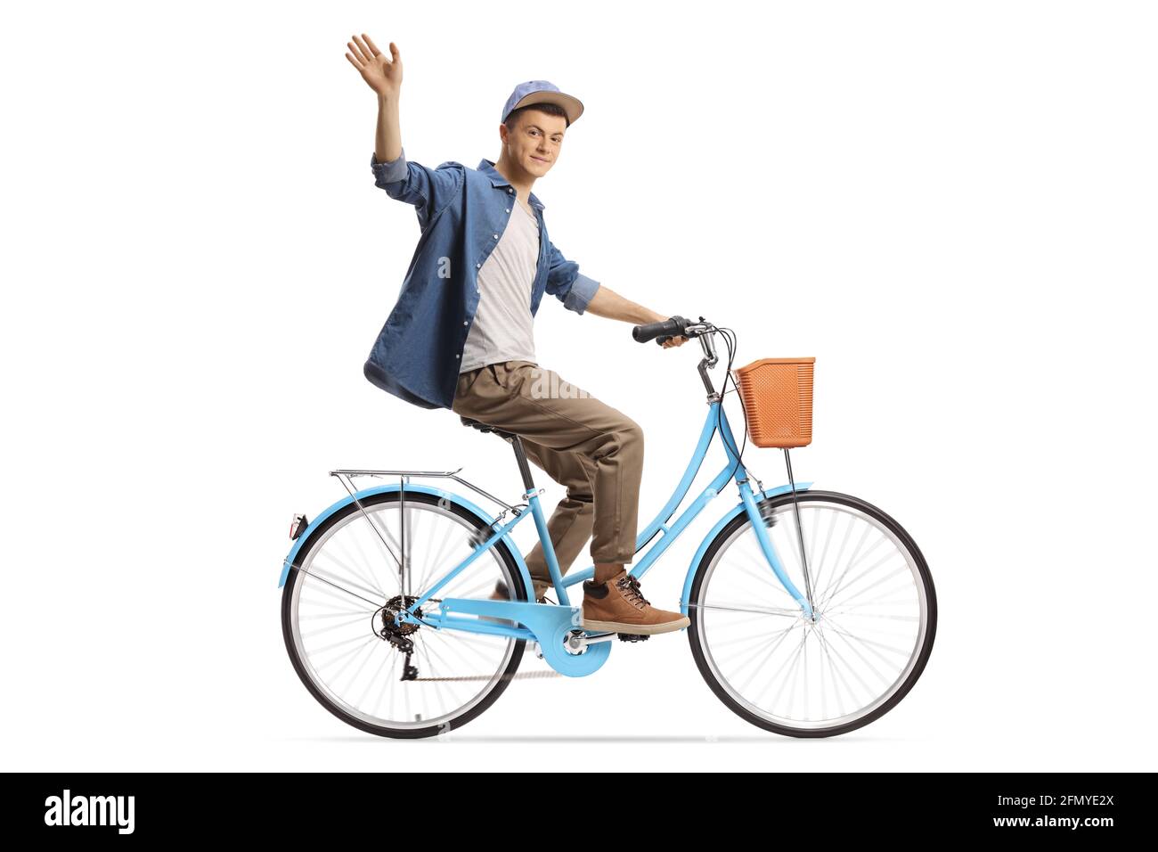 Full length profile shot of a guy riding a city bicycle and waving at ...