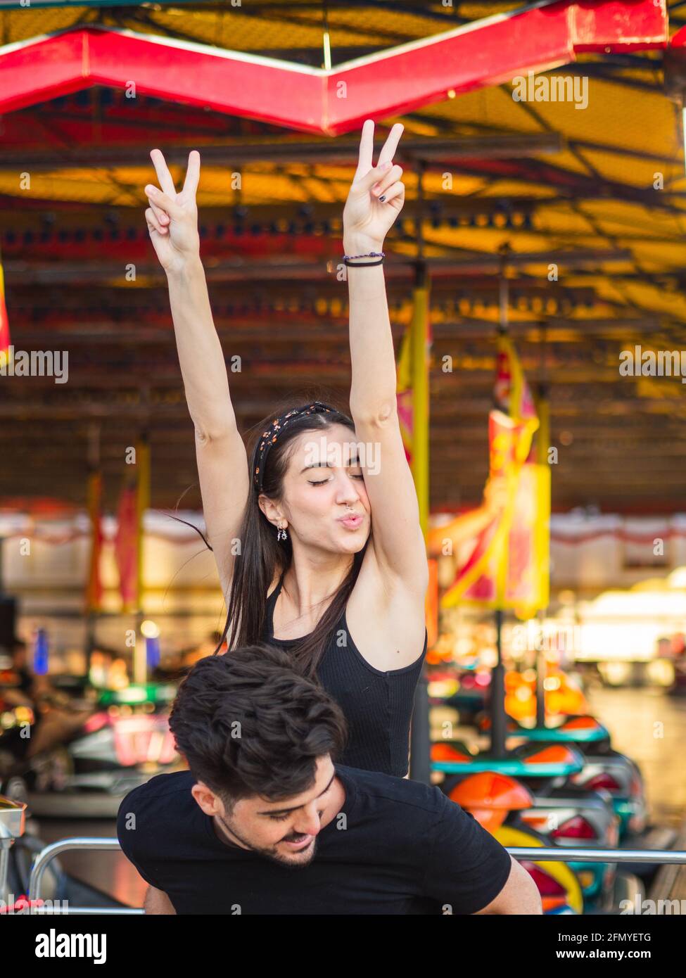 Spanish couple having fun in an amusement park Stock Photo - Alamy