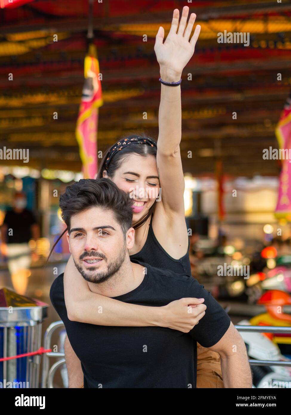 Spanish couple having fun in an amusement park Stock Photo - Alamy
