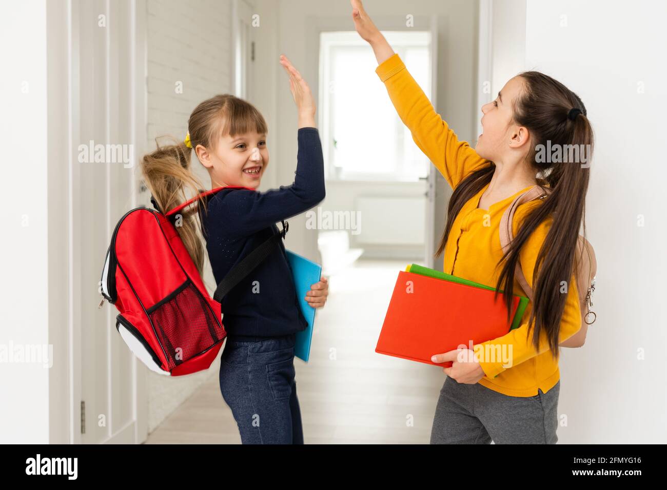 elementary school girls walking in classroom building Stock Photo - Alamy