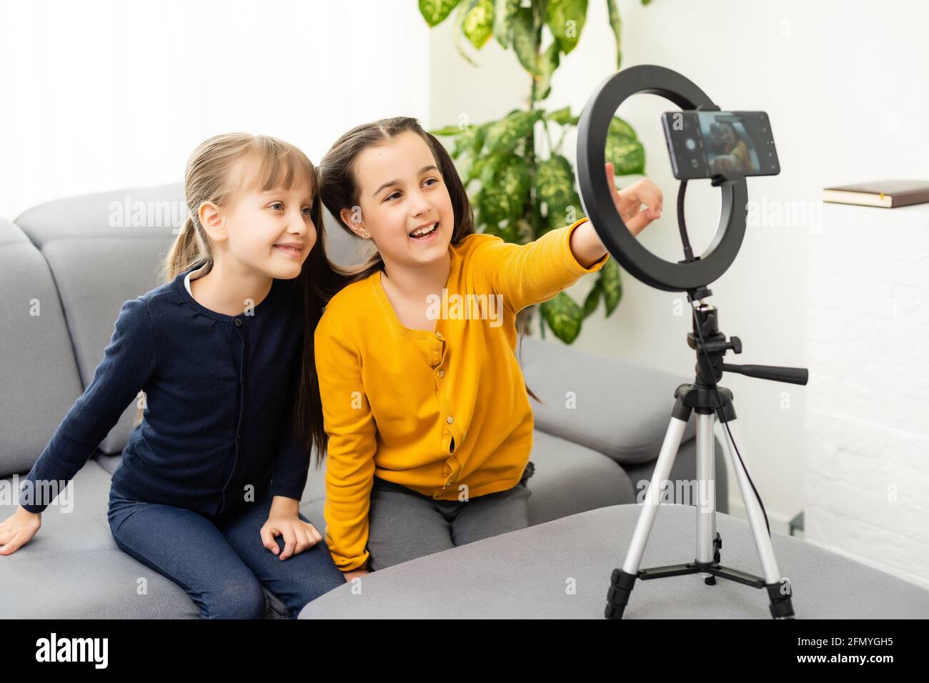 Close up photo two little girls take selfies, talk, tell, speak Stock ...