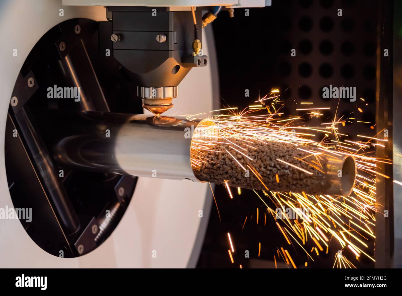 Cnc laser cutting machine working with cylindrical metal workpiece with ...