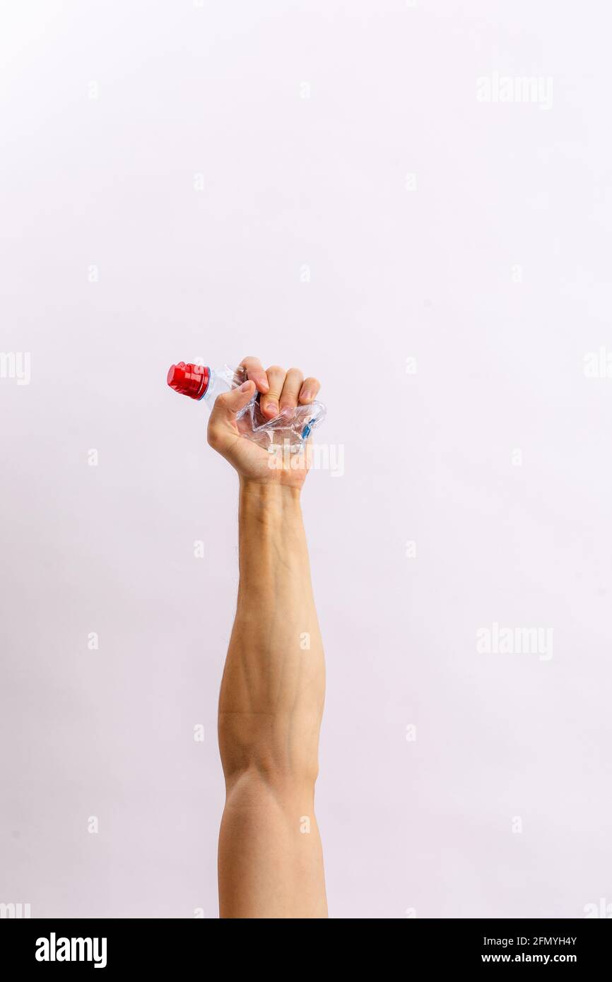 Hands hold trash on a light background. The concept of separate trash ...