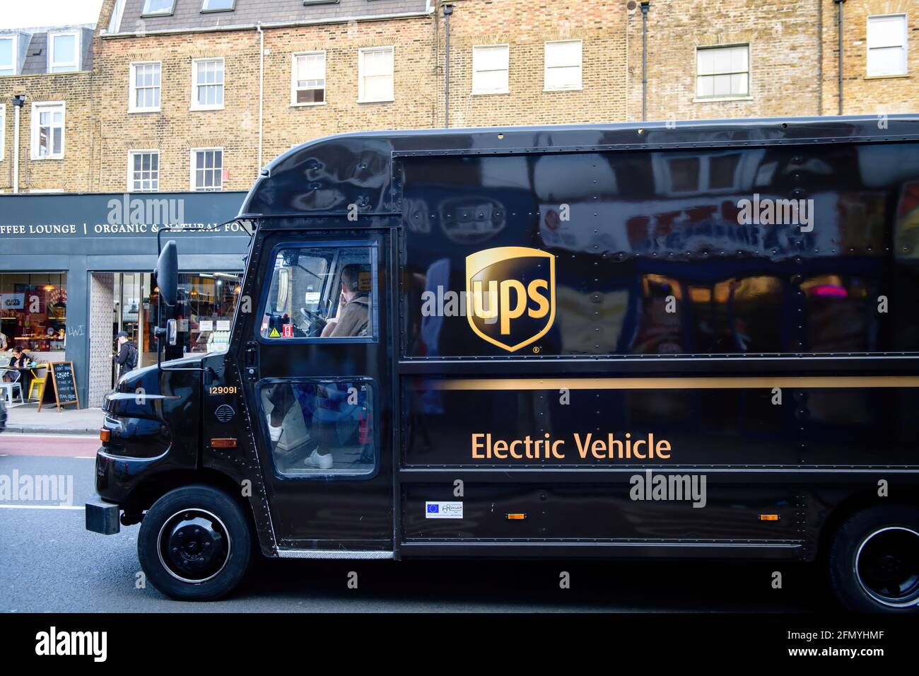Electric Vehicle UPS United Parcel Services postal delivery van driving ...
