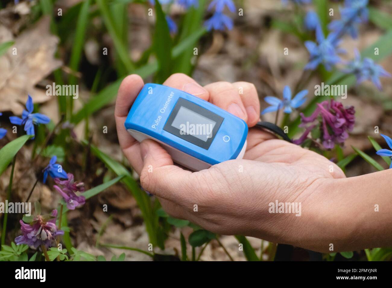 Hand holding Pulse Oximeter. Blue oxygen saturation meter (SPO2 ...