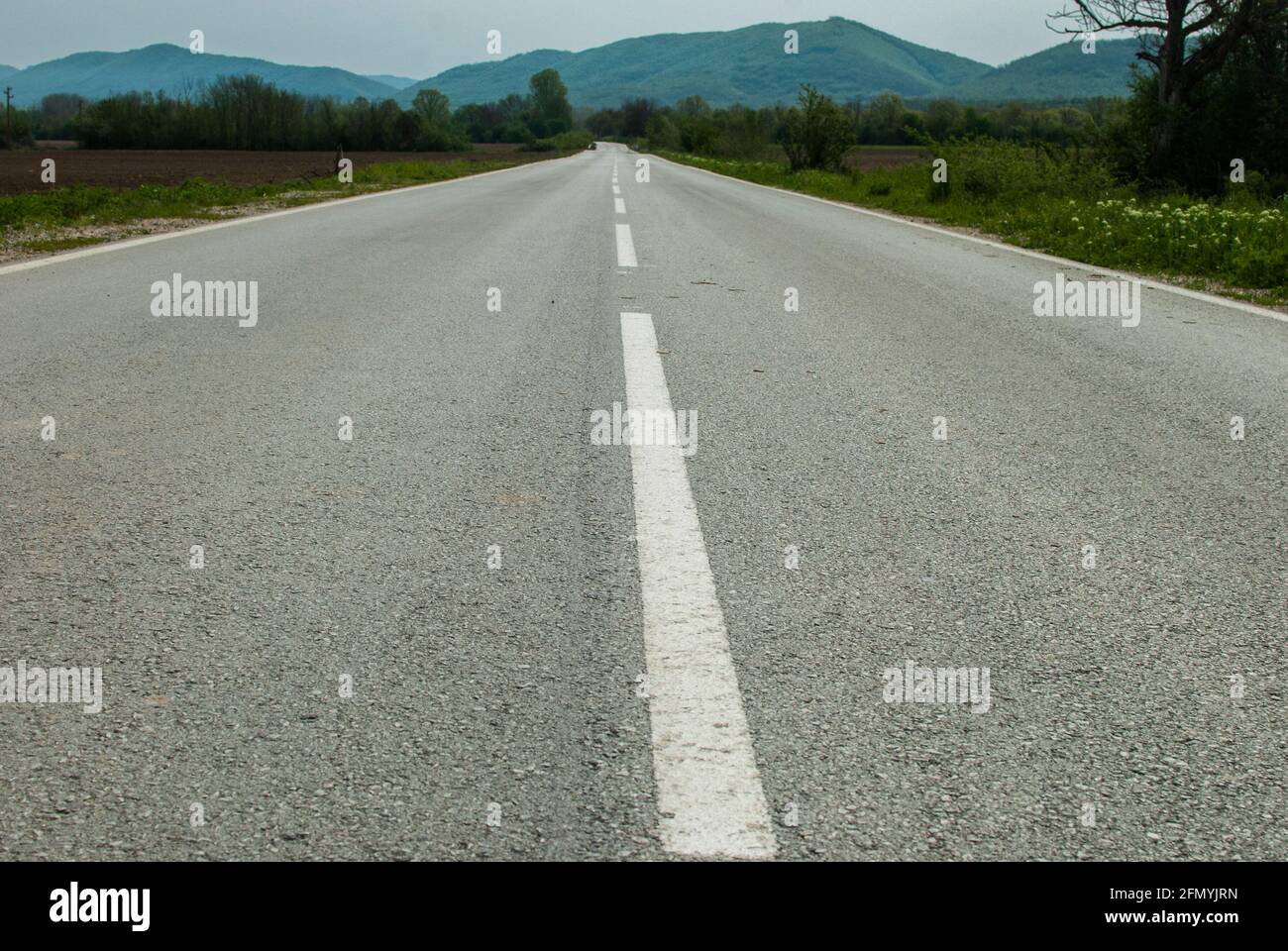 Asphalt surface of country road closeup on countryside landscape ...