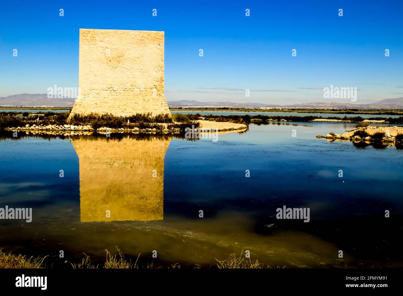 Beautiful Tamarit tower surrounded by salt lagoons in Santa Pola ...