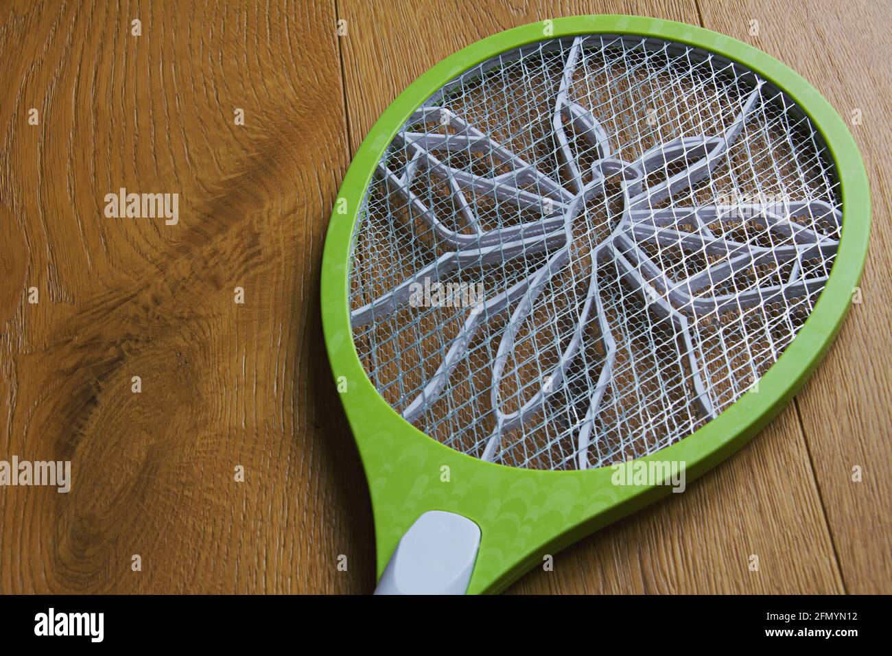 Photo of a insect killer racket in a wooden background Stock Photo - Alamy