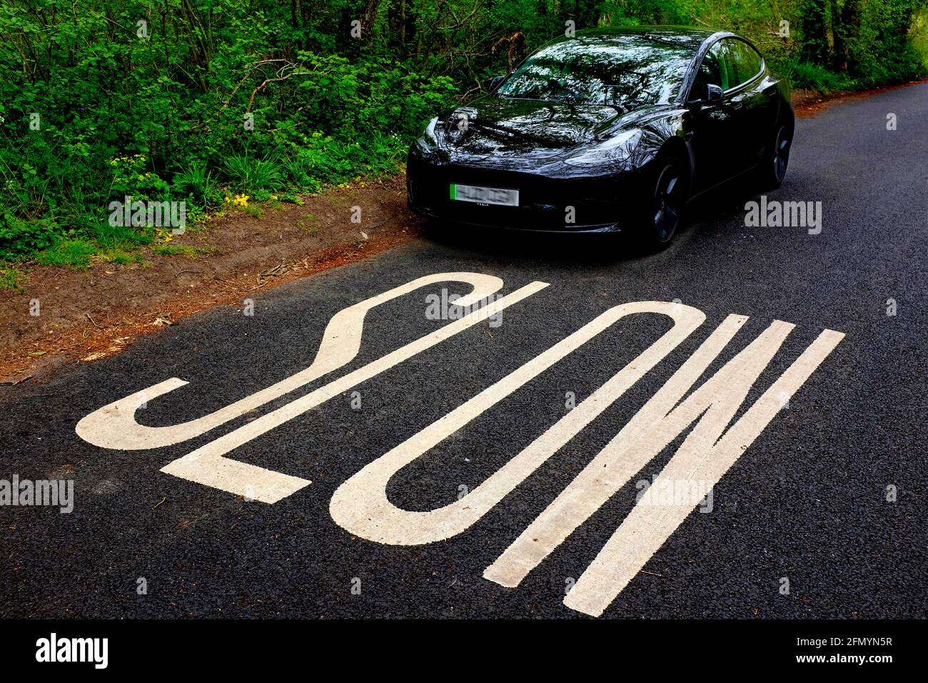 Tesla,Model 3,country road,slow,sign,Newtown,Isle of Wight,England,UK ...