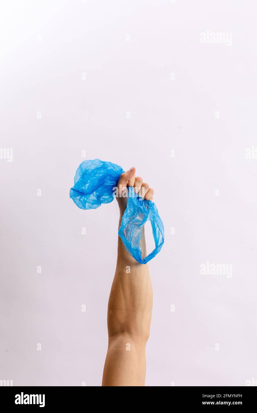 Hands hold trash on a light background. The concept of separate trash ...