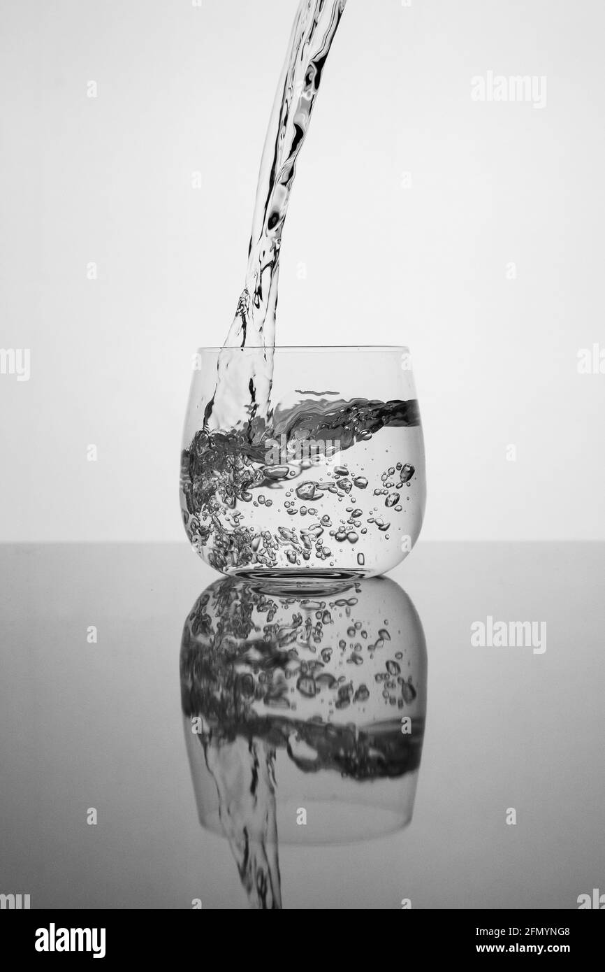 pouring water into glass Stock Photo - Alamy
