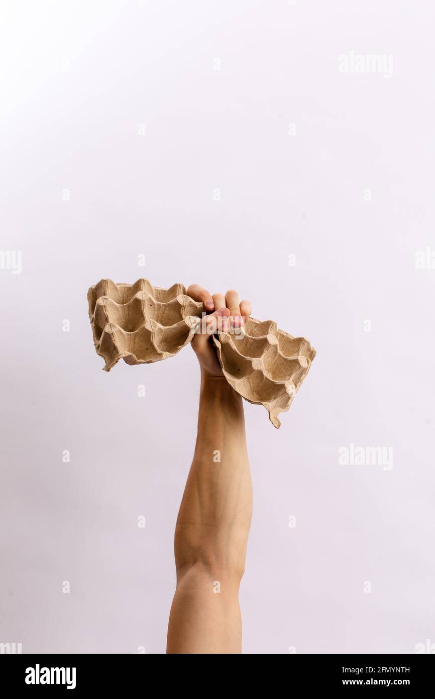 Hands hold trash on a light background. The concept of separate trash ...