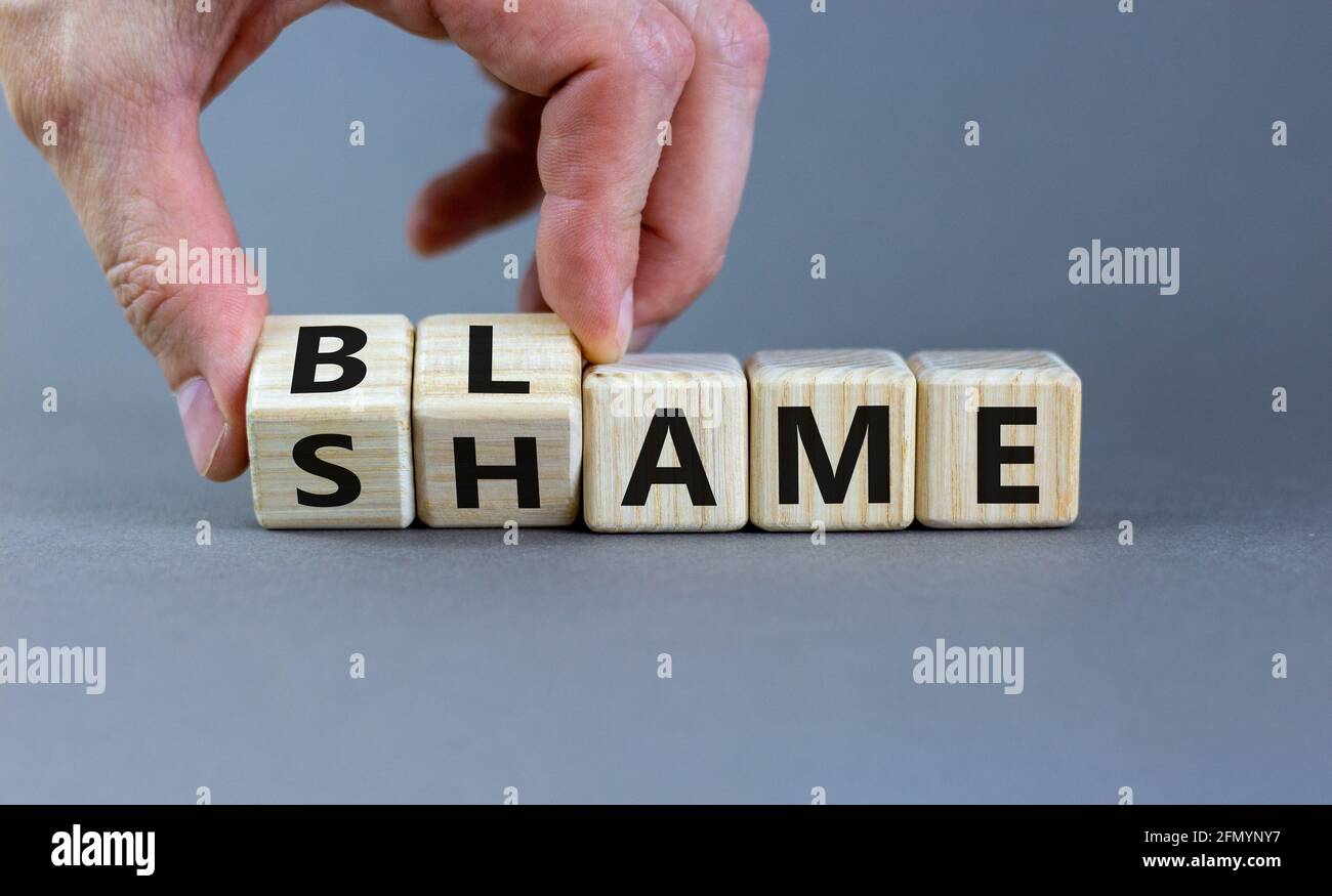 Blame or shame symbol. Businessman turns wooden cubes and changes the ...