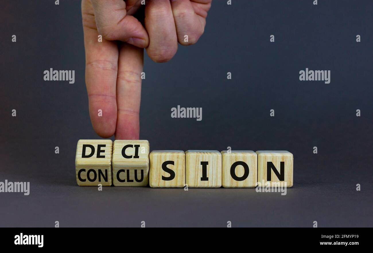 Decision or conclusion symbol. Businessman turns wooden cubes and ...