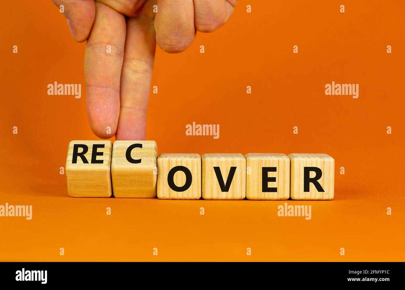 Time to recover symbol. Businessman turns wooden cubes and changes the ...