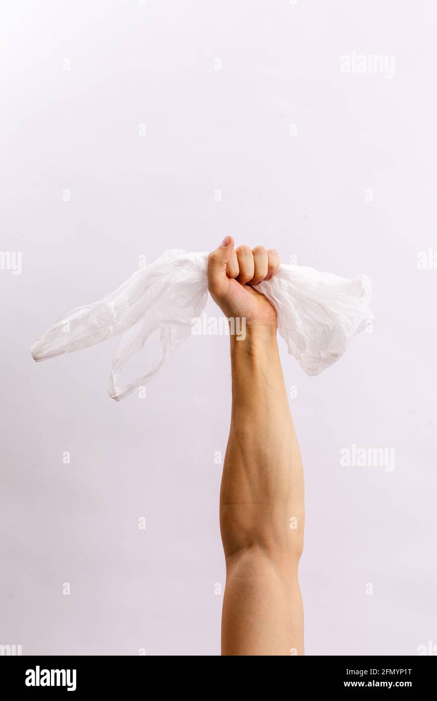 Hands hold trash on a light background. The concept of separate trash ...