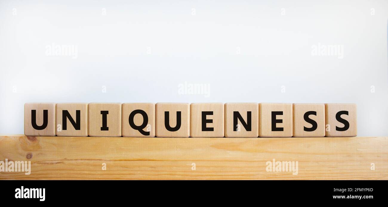 Inclusiveness and uniqueness symbol. Wooden cubes with the word ...