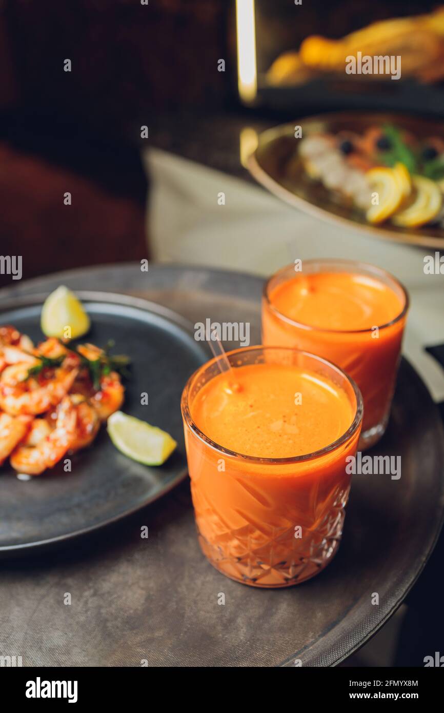 Cocktail being poured at a bar. Motion blur of the bartender's hand and ...