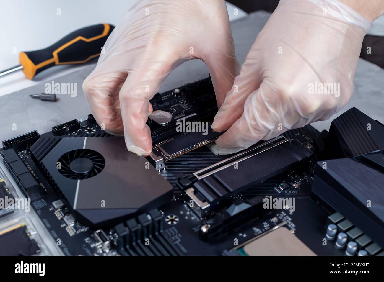Technician is installing new fast high capacity SSD drive on the ...