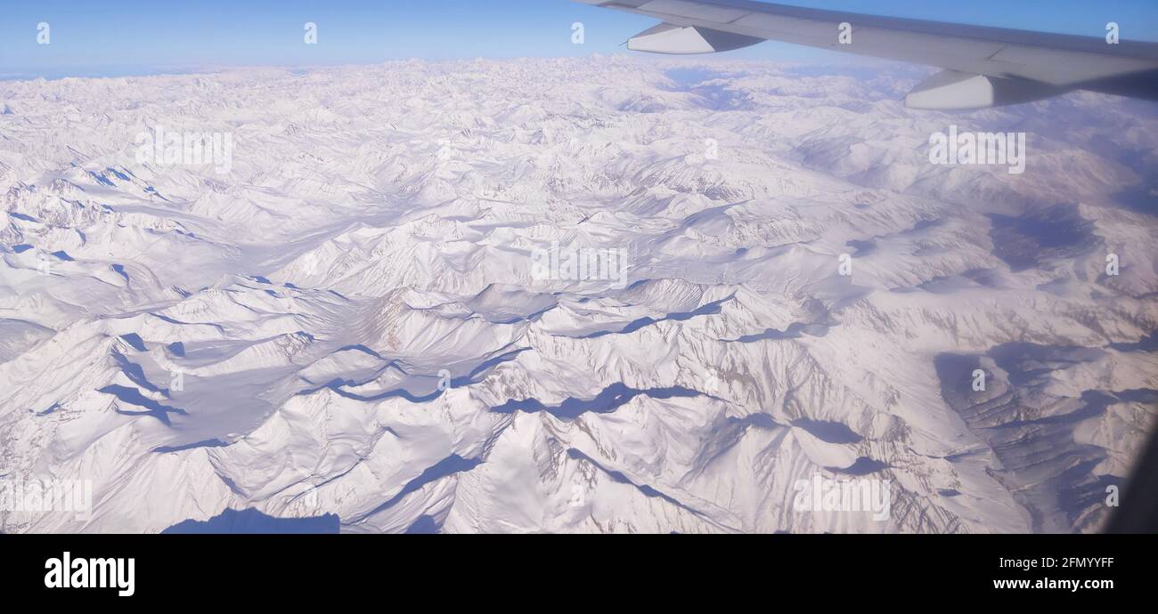 Winter mountains from the plane window Stock Photo - Alamy