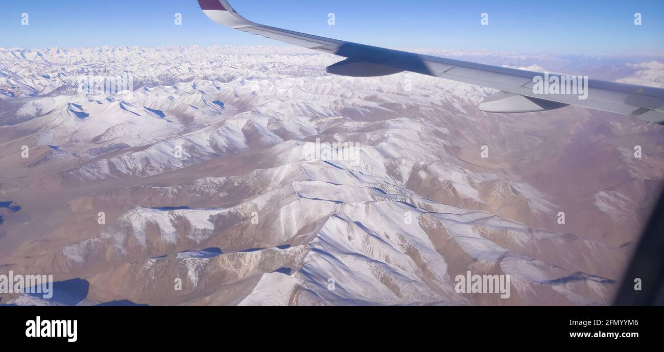 Winter mountains from the plane window Stock Photo - Alamy