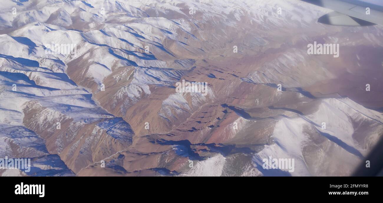 Winter mountains from the plane window Stock Photo - Alamy