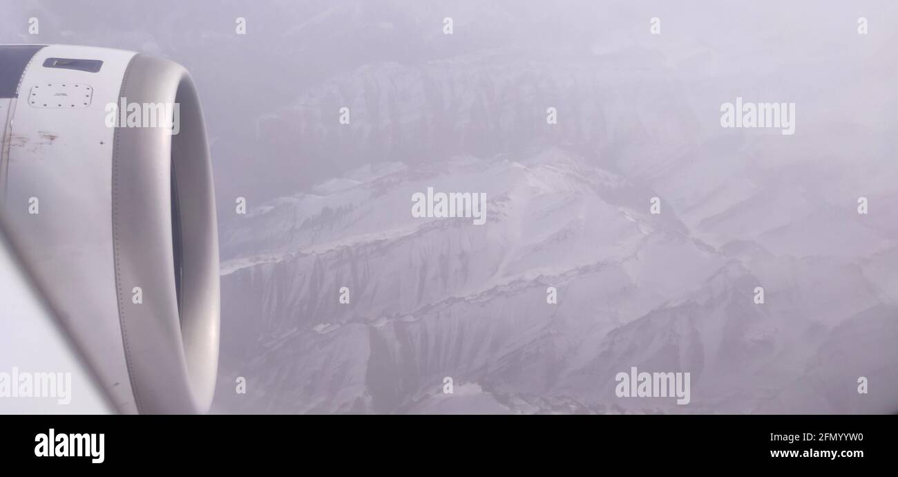 Winter mountains from the plane window Stock Photo - Alamy