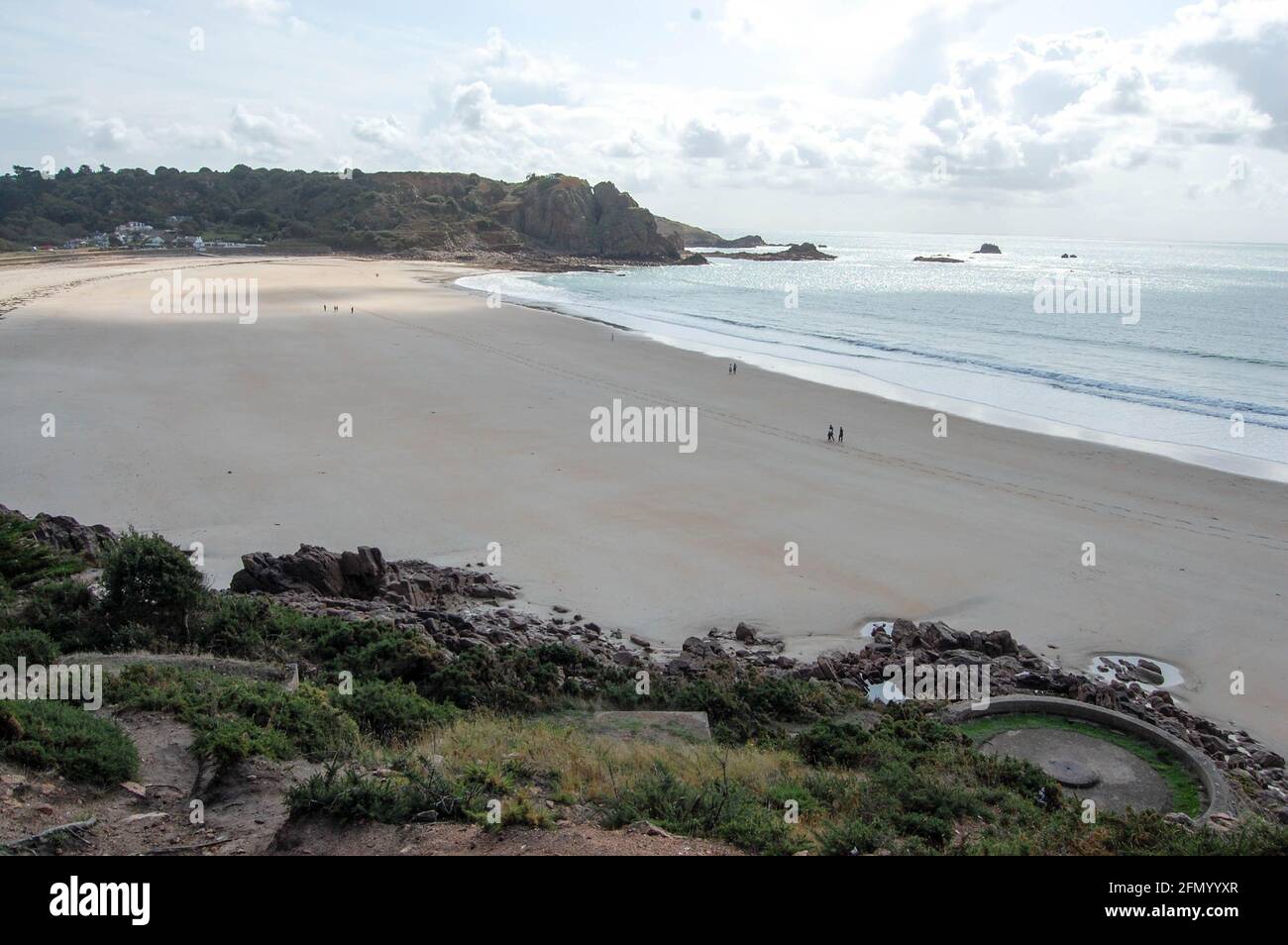 Sandy coast beach people walking in Jersey channel islands UK sea sand ...