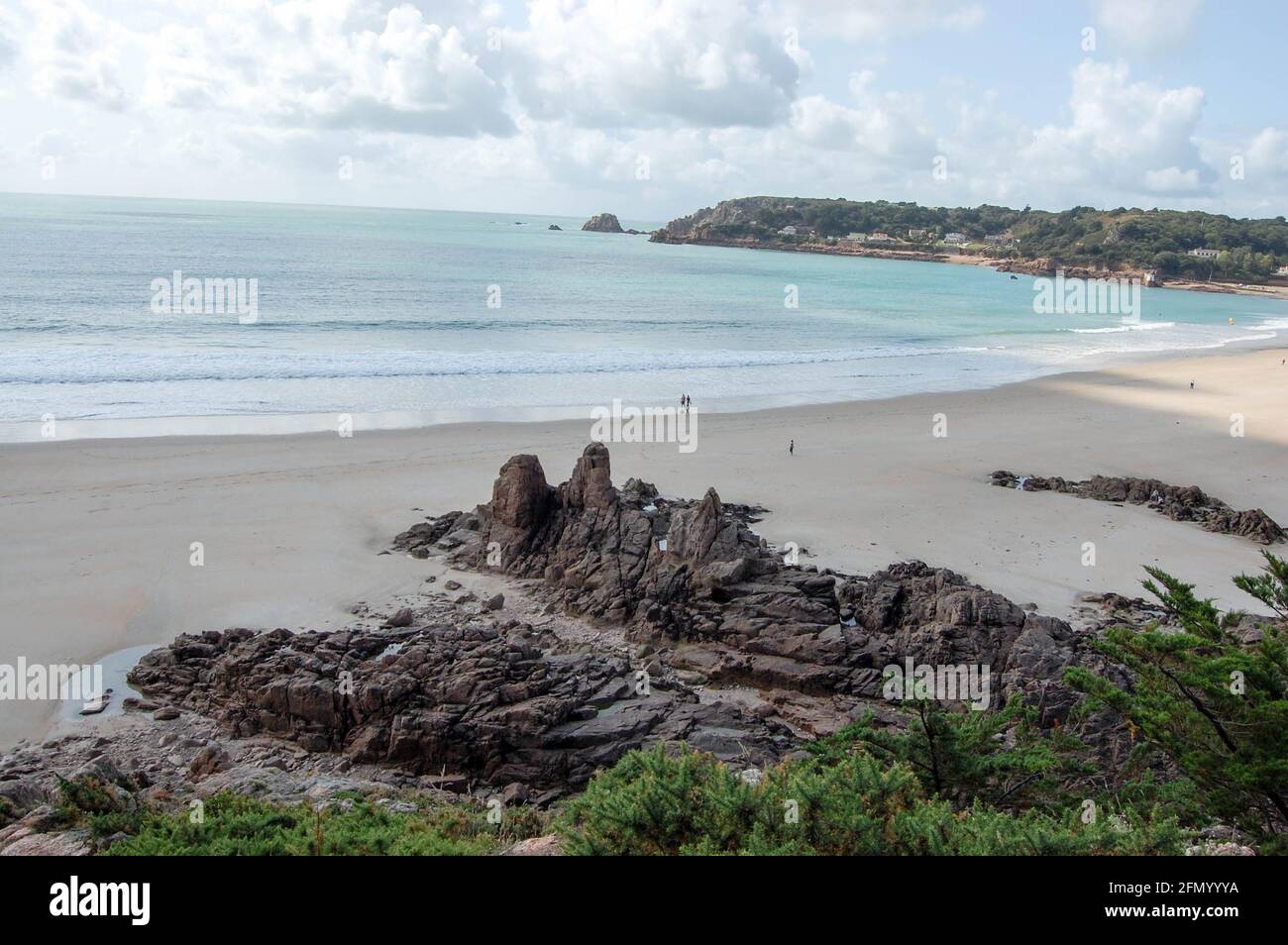 Sandy beach in Jersey channel islands UK with rocks and low clouds ...