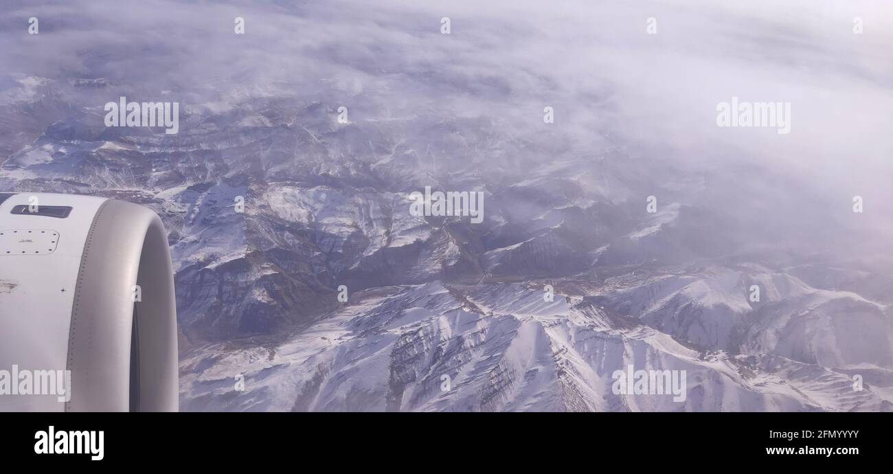 Winter mountains from the plane window Stock Photo - Alamy