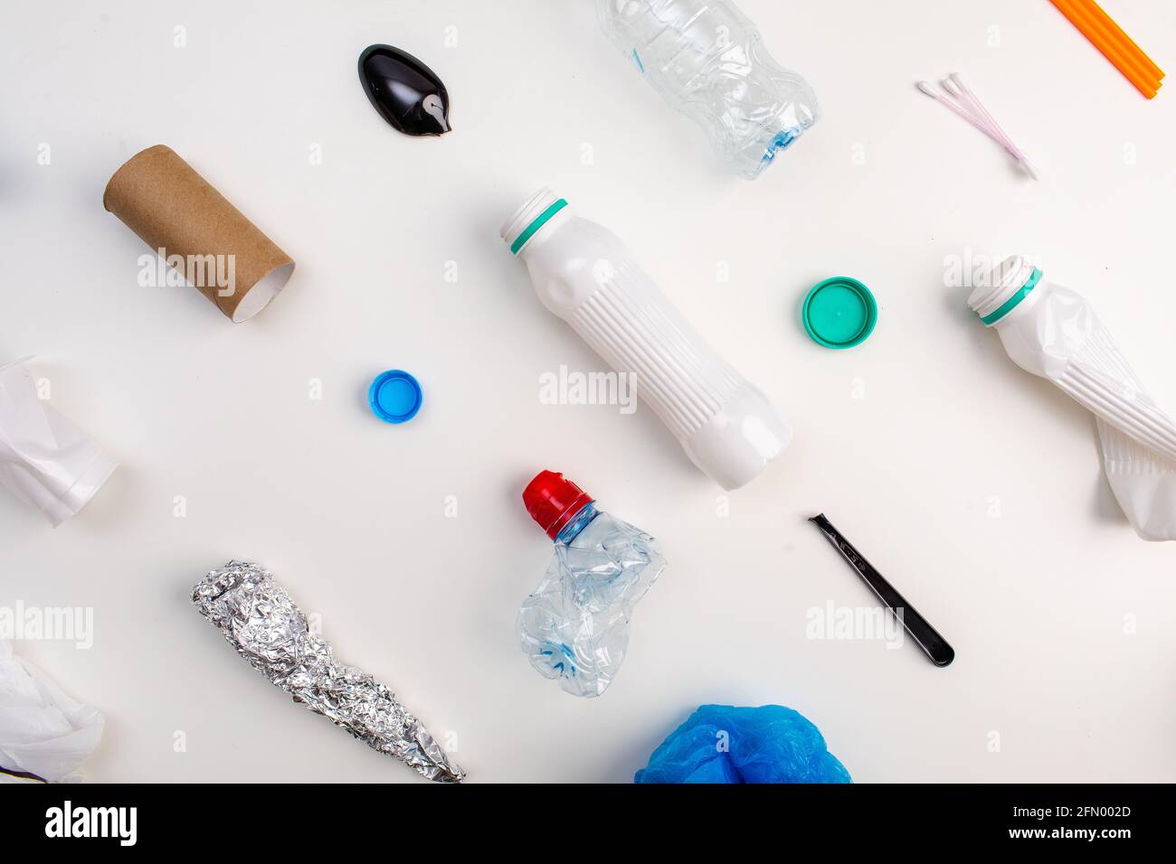 plastic trash on a white background. environmental pollution. Flay lay ...