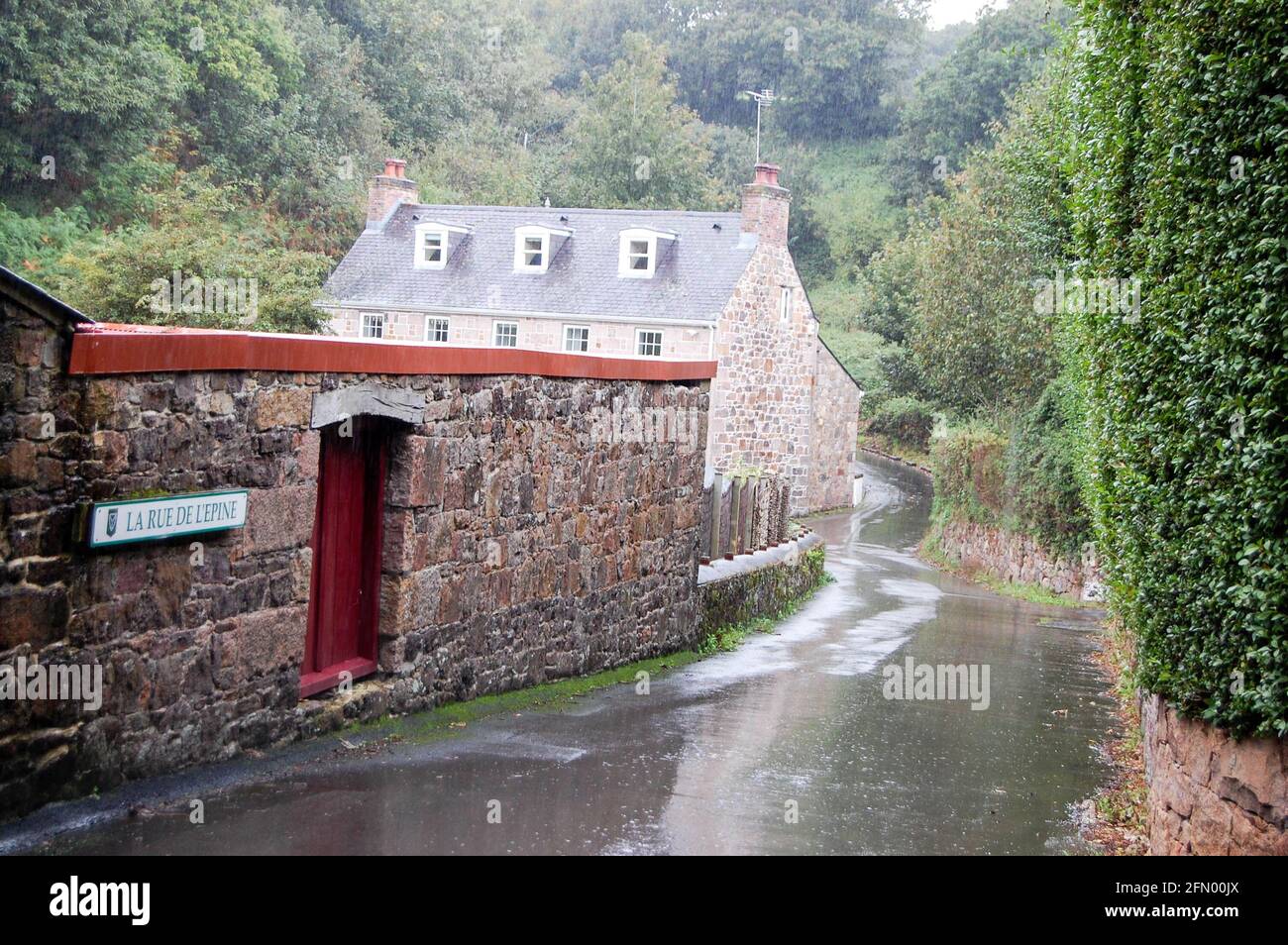French style house street sign and stone wall flooding in street heavy ...