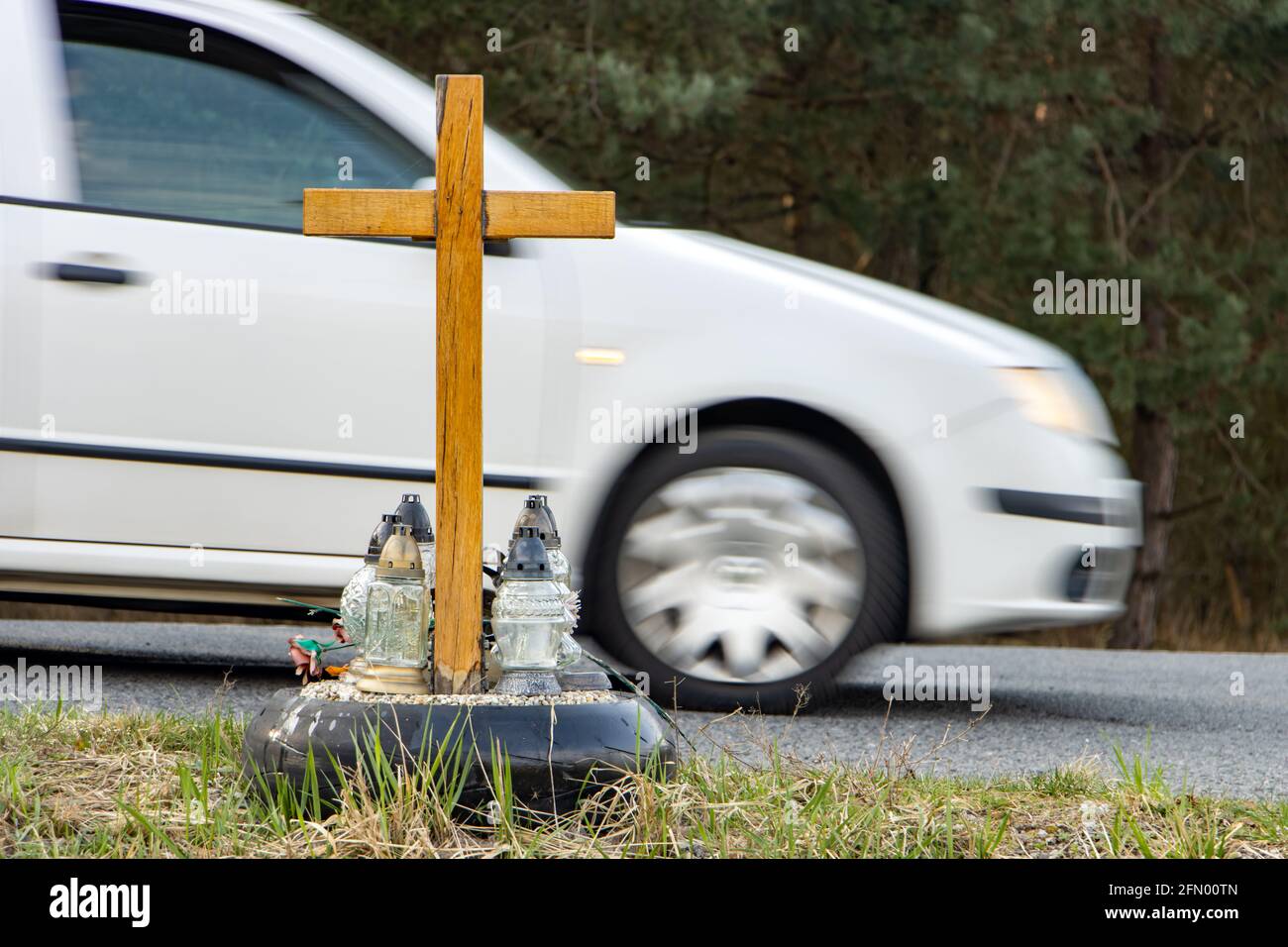 A roadside memorial cross with a candles commemorating the tragic death ...